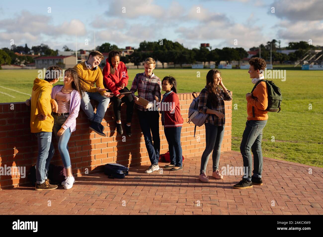 Teenagers hanging out in their school grounds Stock Photo - Alamy