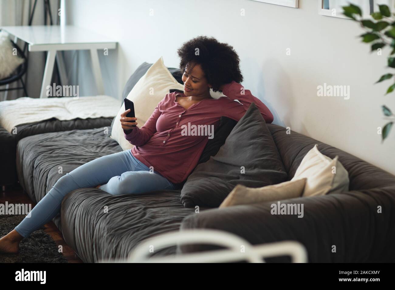 Woman relaxing at home Stock Photo - Alamy