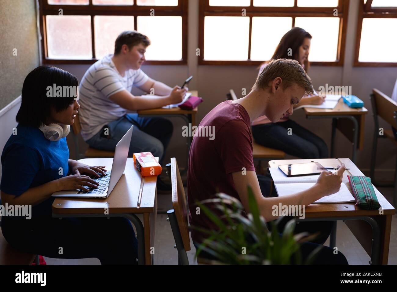 Teenagers in school classroom Stock Photo - Alamy