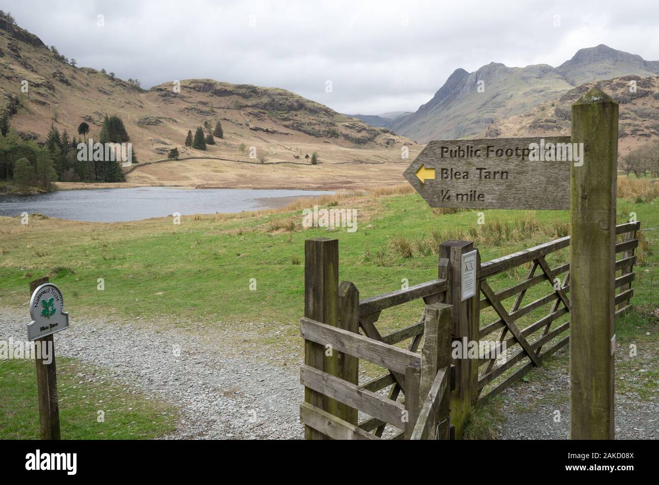 Gate and signpost on the roadside at the beginning of the footpath ...