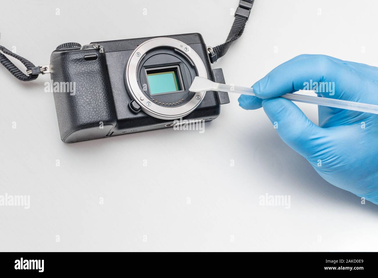 Cleaning the digital camera matrix. Digital camera service. The master ...