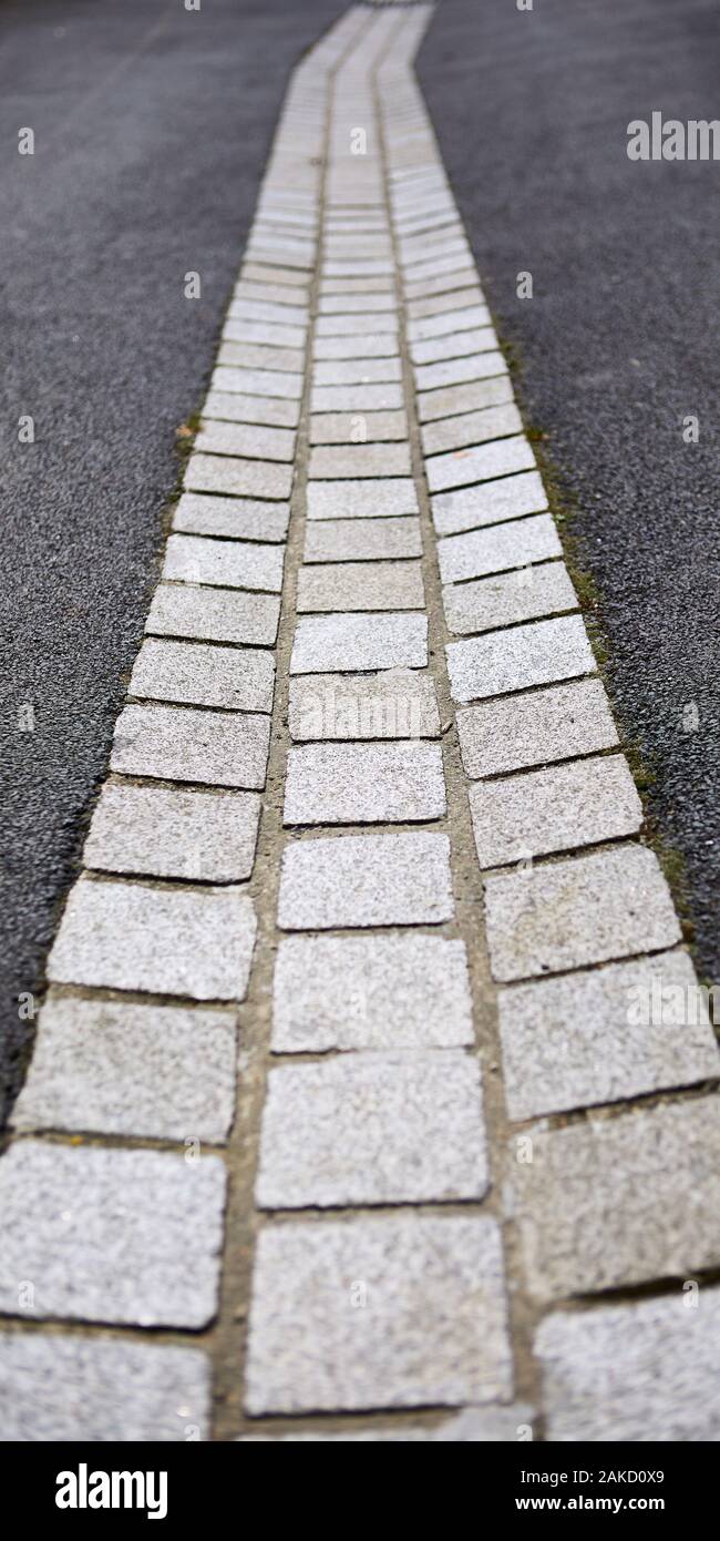 Abstract image of cobbled gully drain with tarmac sides sections Stock ...
