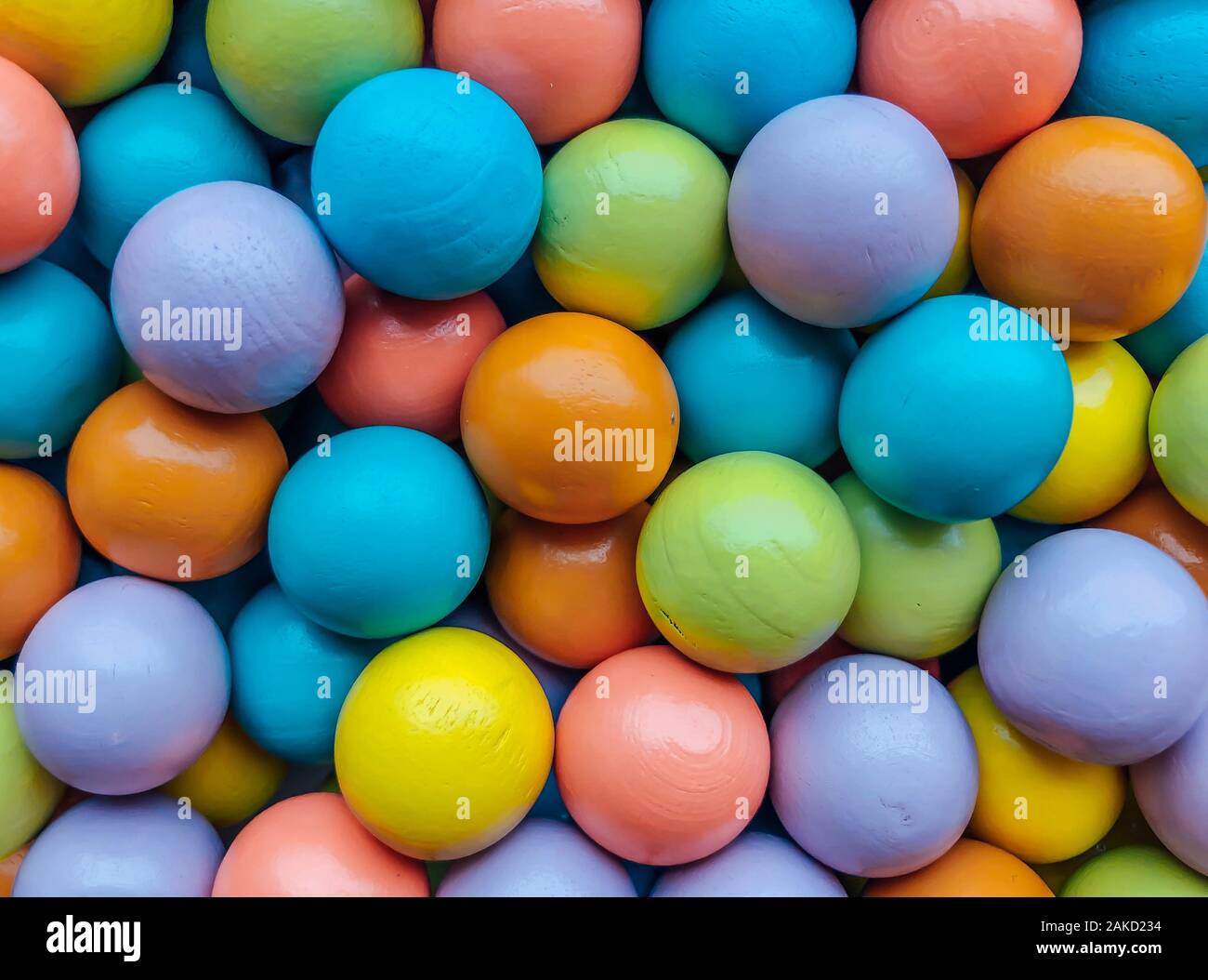 Bright multi-colored background from small wooden colored balls from ...