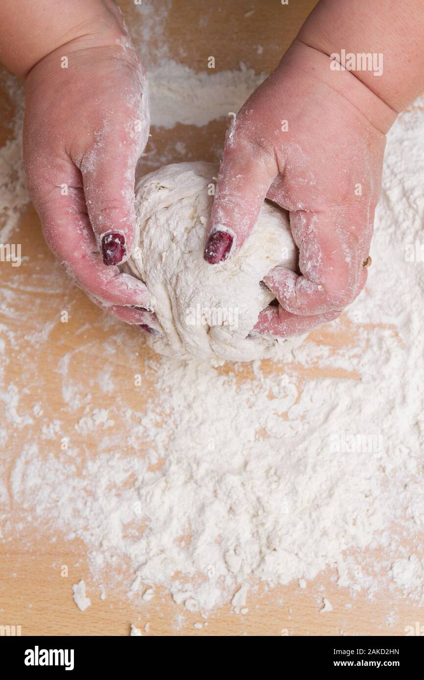 Kneading dough with flour on a wooden table at home Stock Photo - Alamy