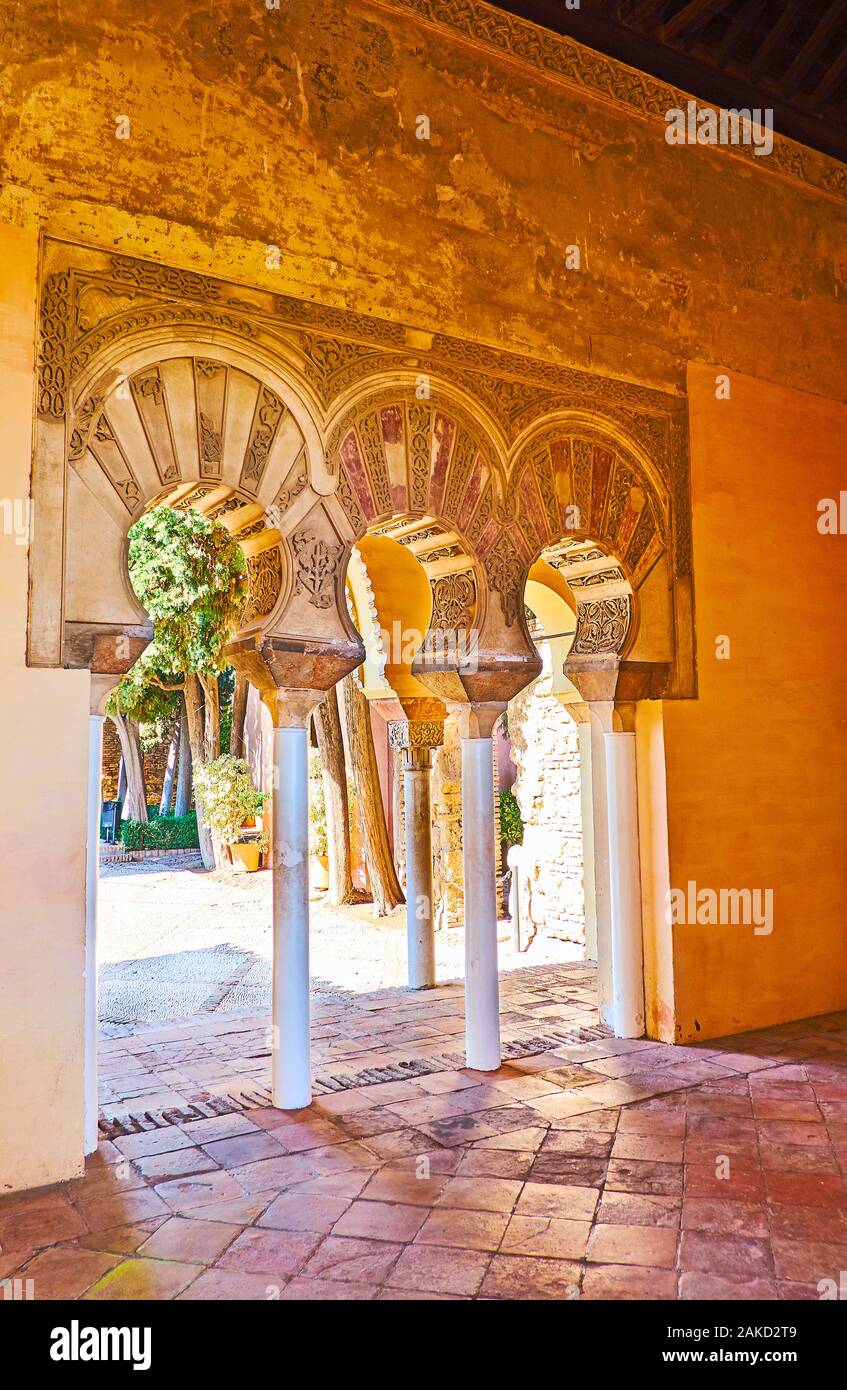 MALAGA, SPAIN - SEPTEMBER 26, 2019: The shady corridor with horseshoe ...
