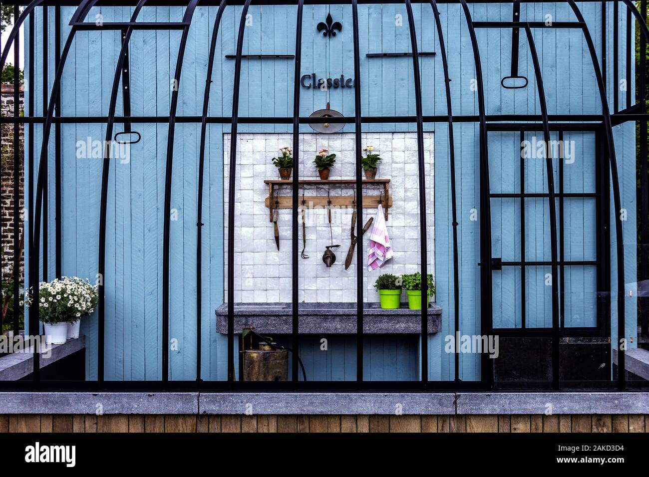 A portrait of an open outdoor gardening shed. The shed is made of a ...