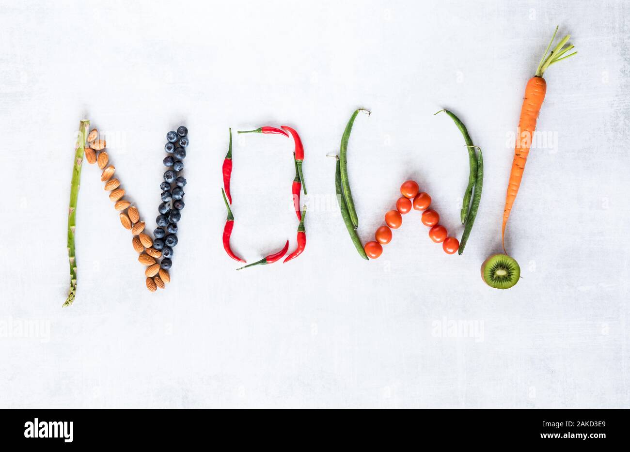 Healthy foods arranged to spell the word now Stock Photo - Alamy