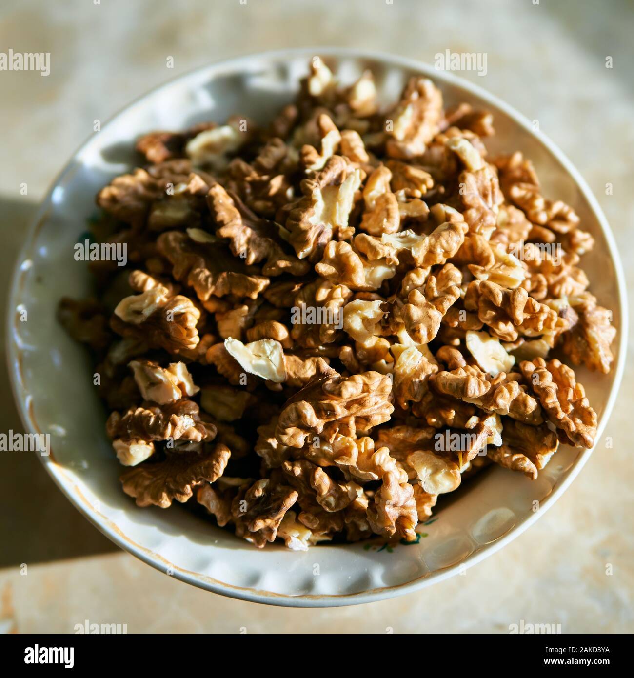 A dish full of peeled kernels of walnut closeup top view Stock Photo ...