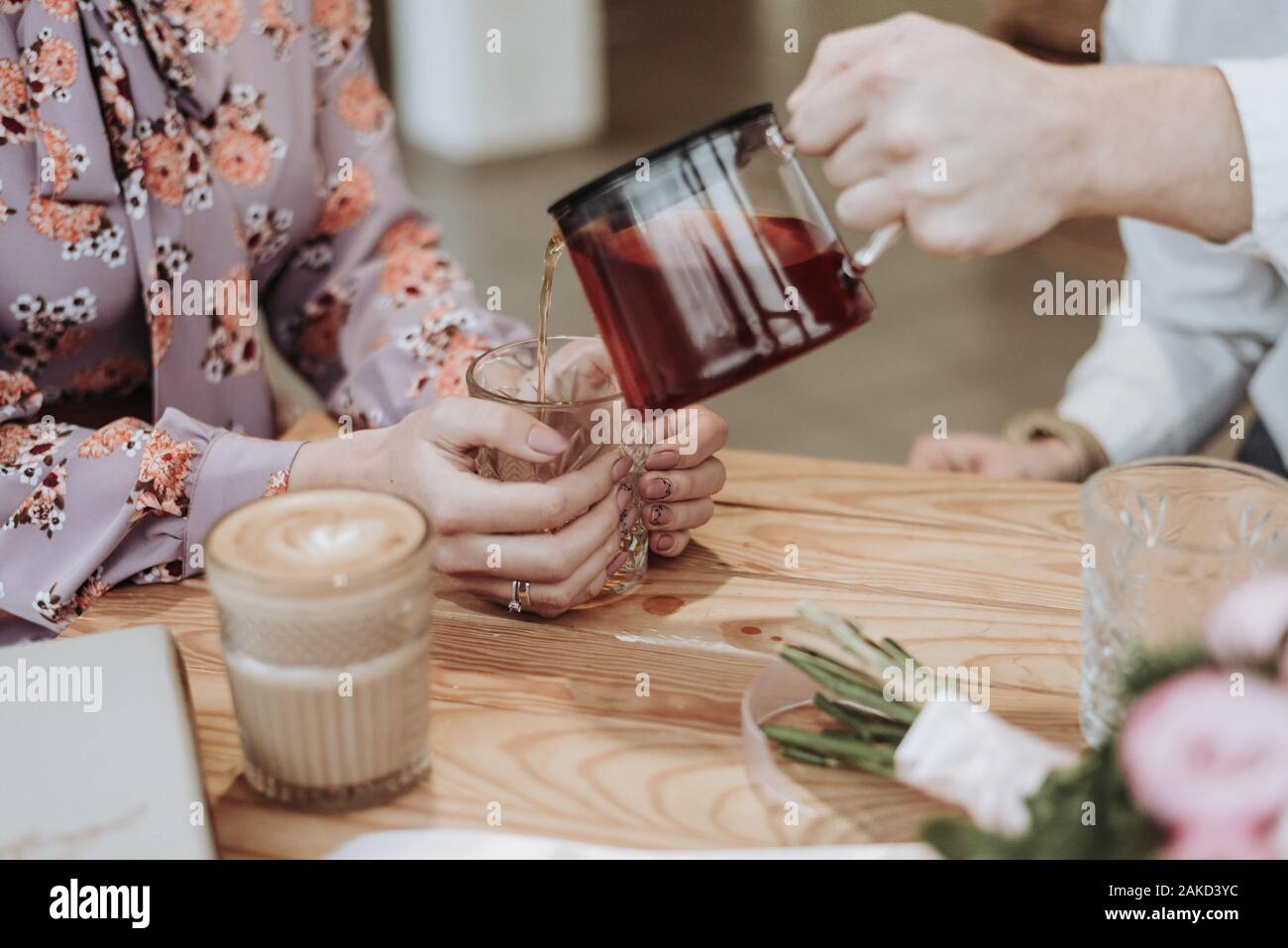 A romantic couple drinking tea, hands with cups Stock Photo - Alamy