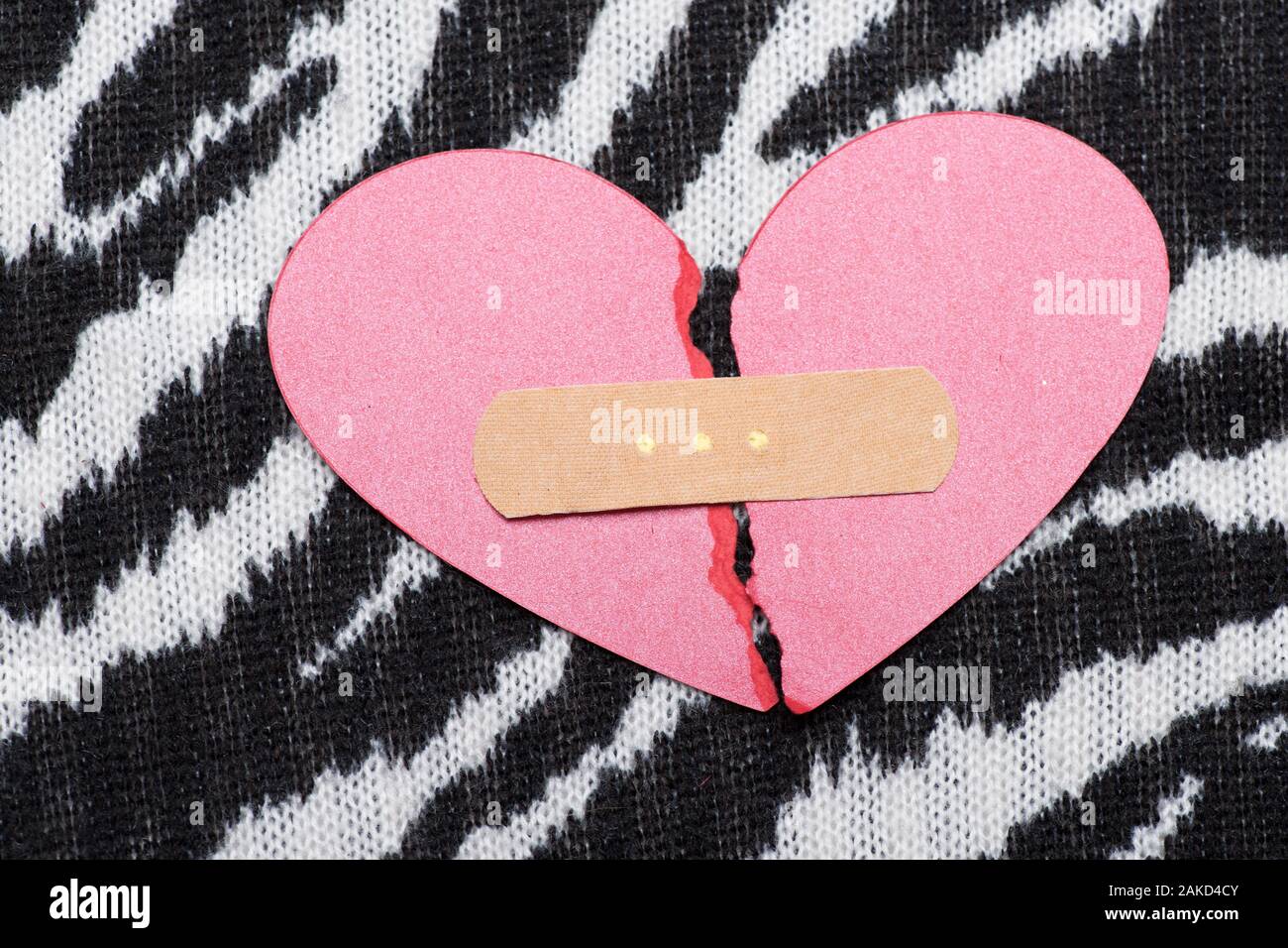 Love and relationship concept. Part of pink broken paper heart glued ...