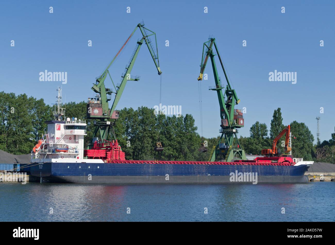 Loading a merchant ship Stock Photo - Alamy