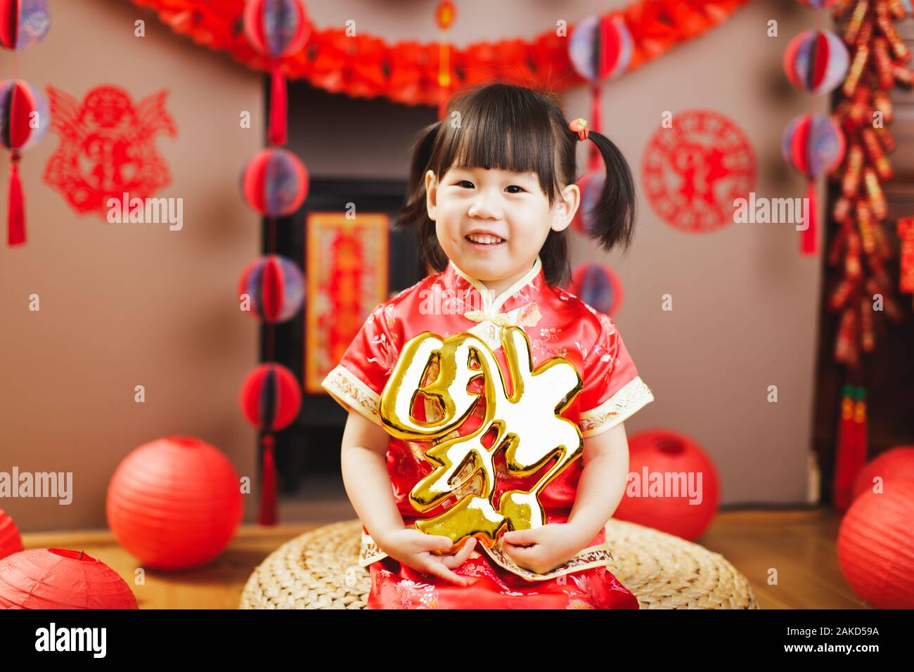 Chinese toddler girl traditional dressing up hold a Fu means 'lucky ...