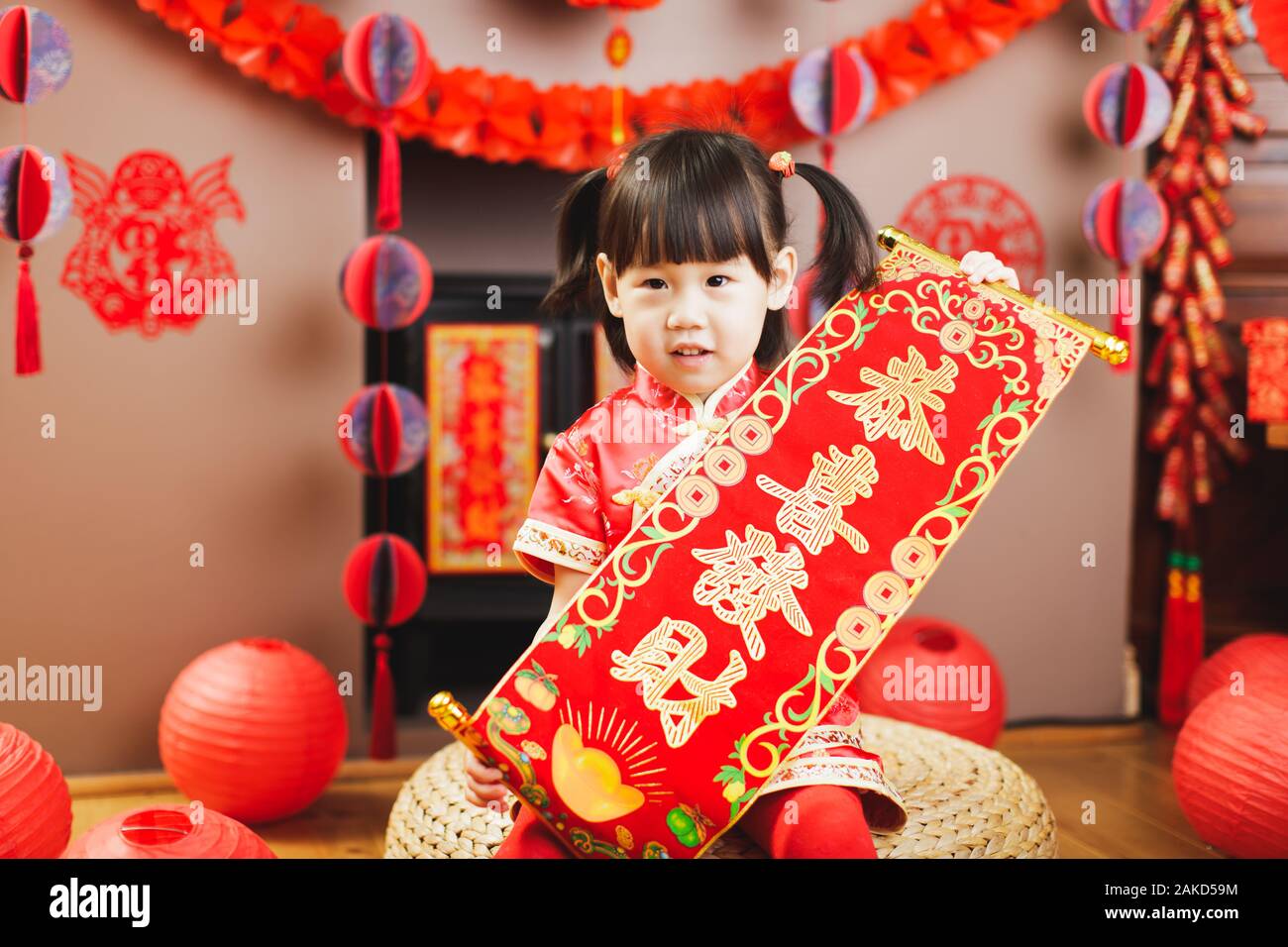 Chinese toddler girl traditional dressing up with a "Gong Xi Fa Cha ...