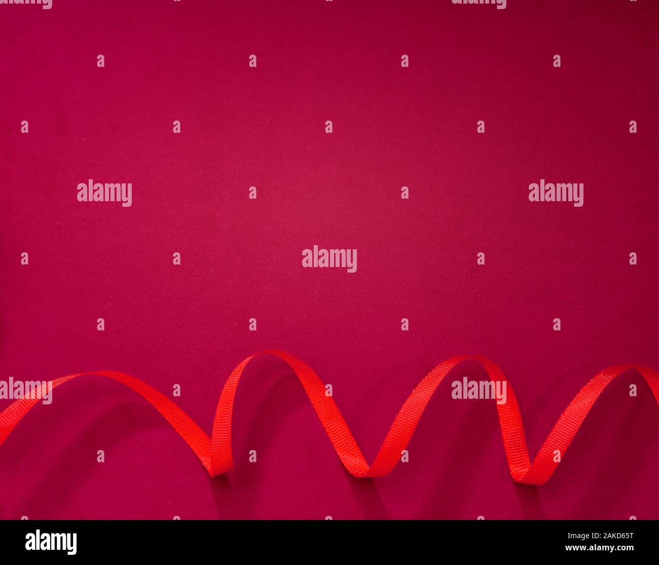 Red ribbon on pink fabric Stock Photo - Alamy