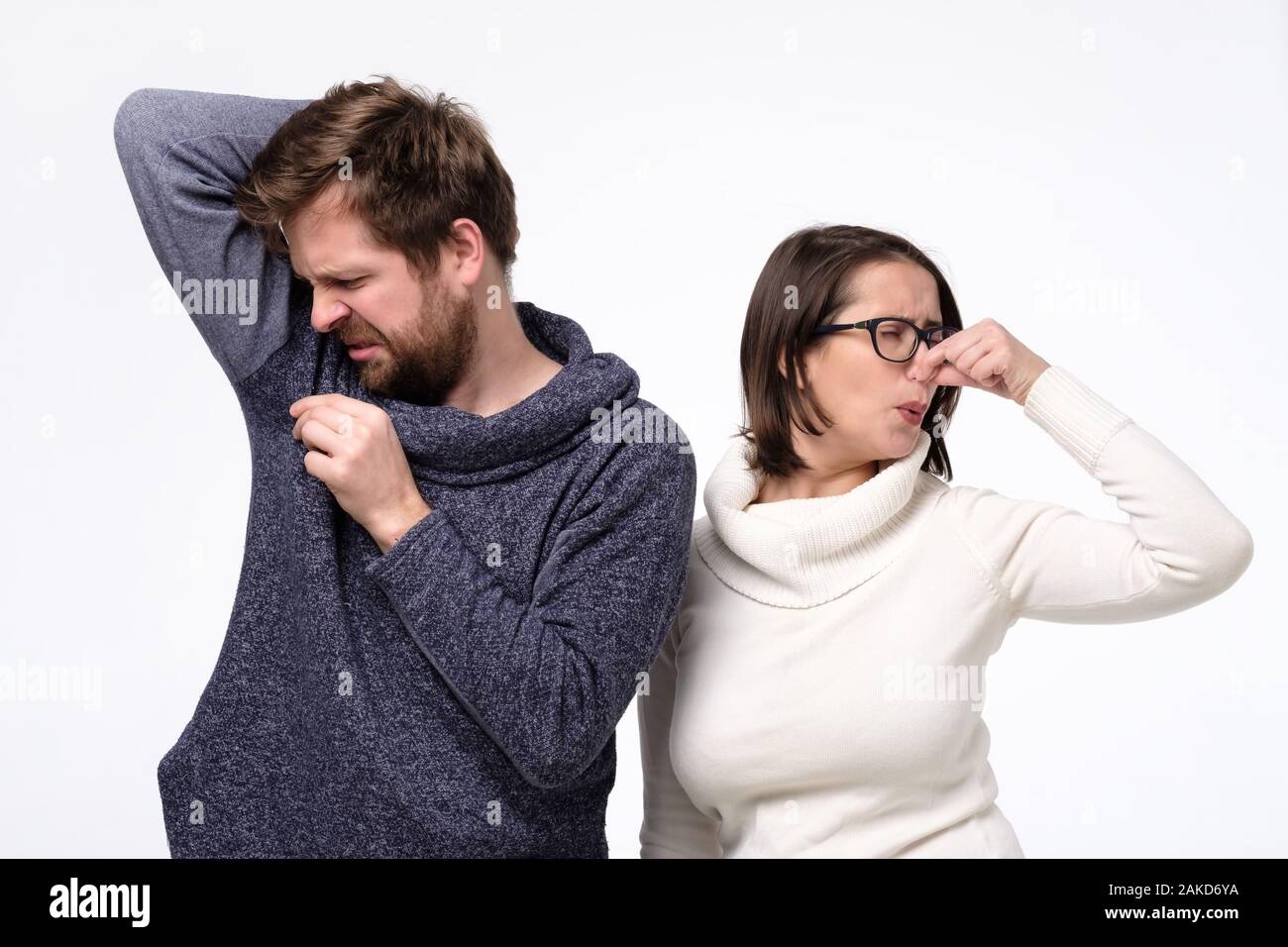 Young man with sweat stain on his clothes and caucasian woman feeling ...