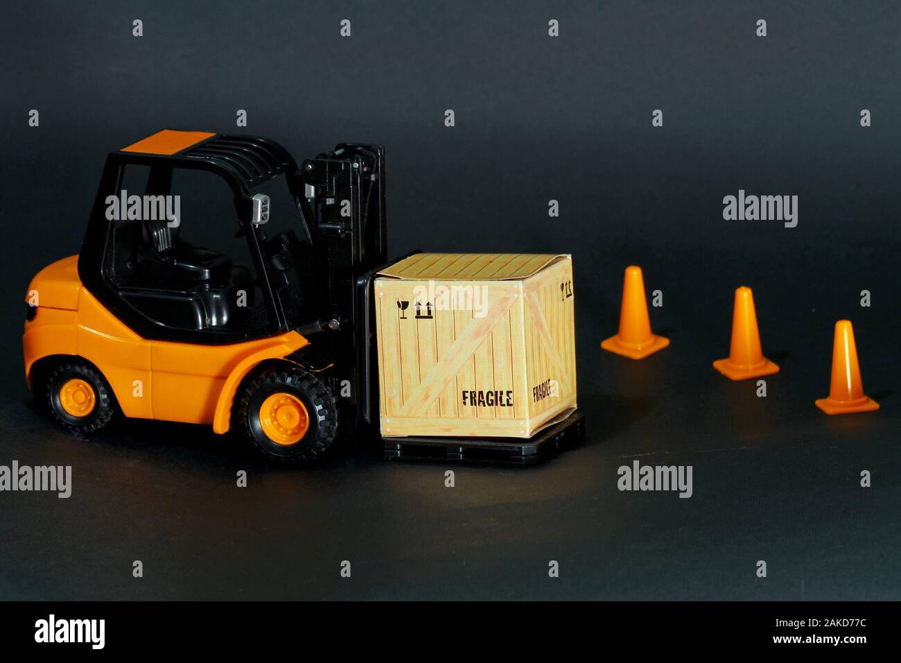 Small forklift vehicle with fragile transportation box Stock Photo - Alamy