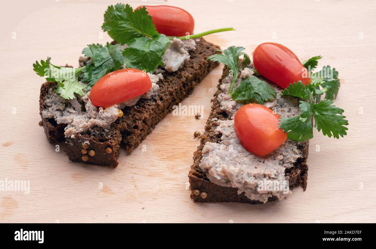 sandwich with black rye bread with pork pate and herbs and cherry ...