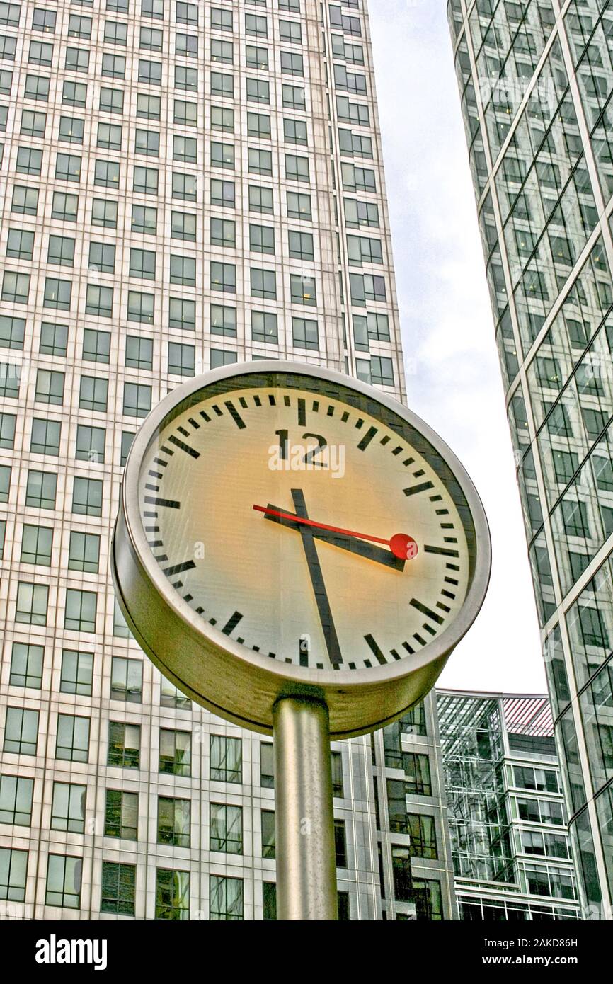 Public clock in front of business building Stock Photo - Alamy