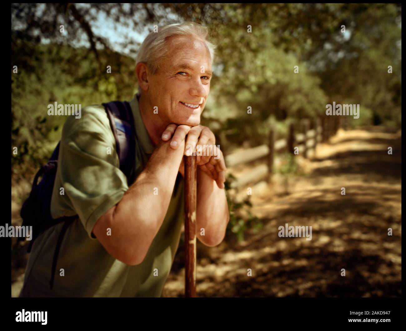 Portrait of a mature adult man resting his head on his hands while ...