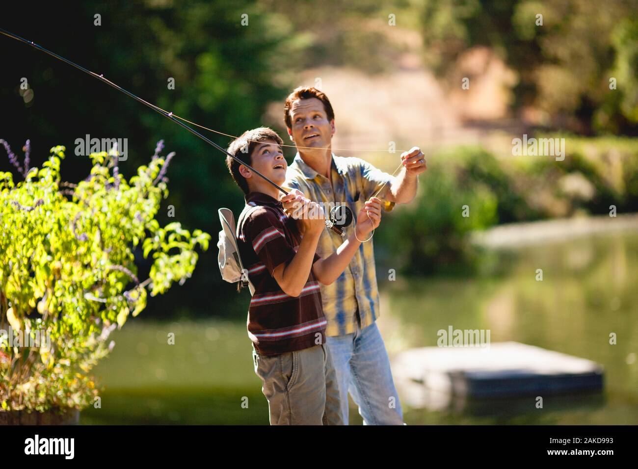 Father and son bonding while fishing on a lake Stock Photo - Alamy