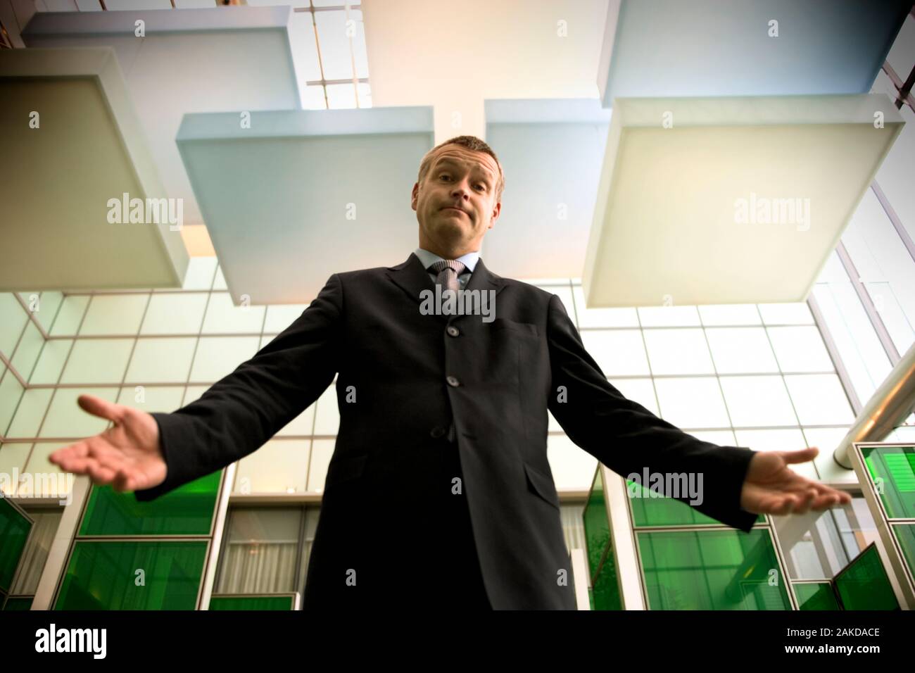 Portrait of a businessman shrugging Stock Photo - Alamy