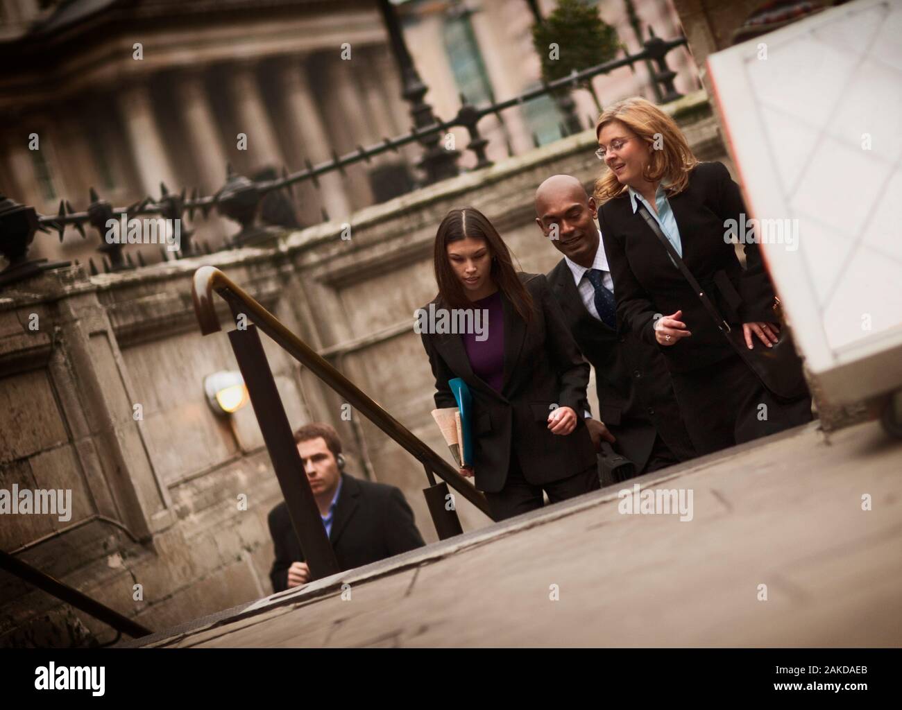 Businesspeople walking up stairs together Stock Photo - Alamy