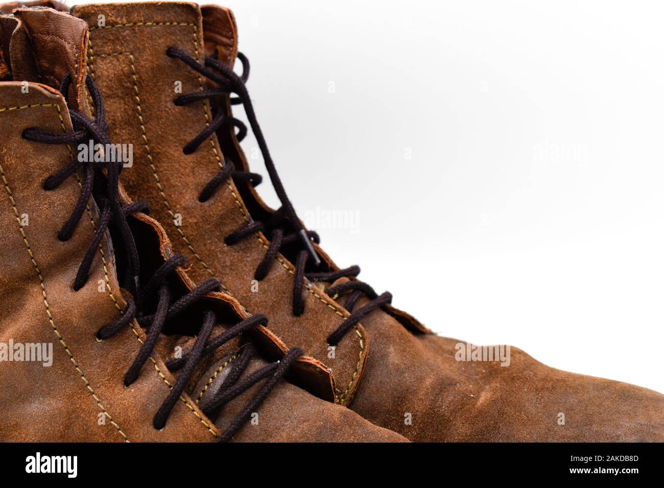close up of the side of a pair of brown mens leather boots isolated on ...