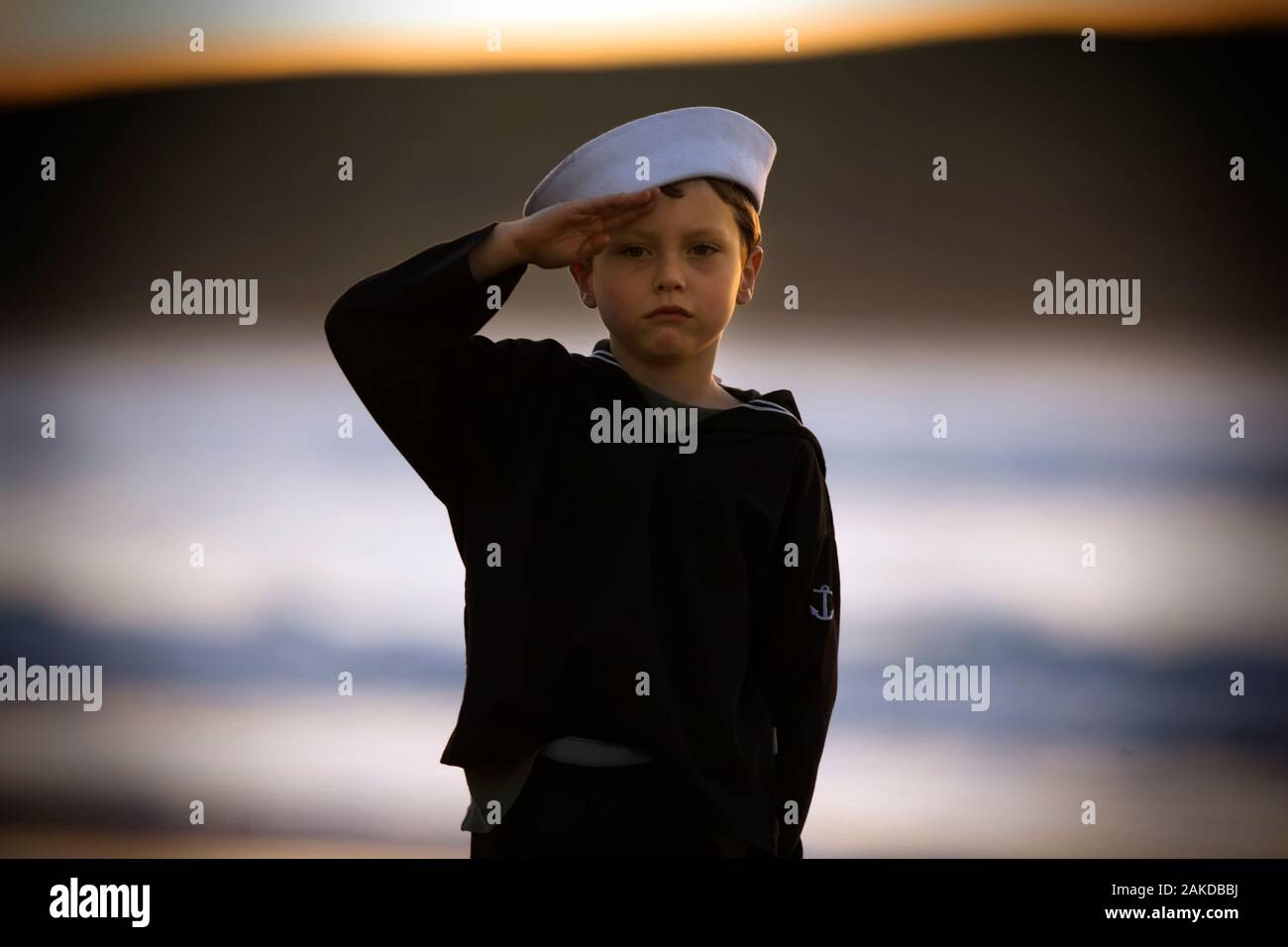 Portrait of a small boy giving a salute Stock Photo - Alamy