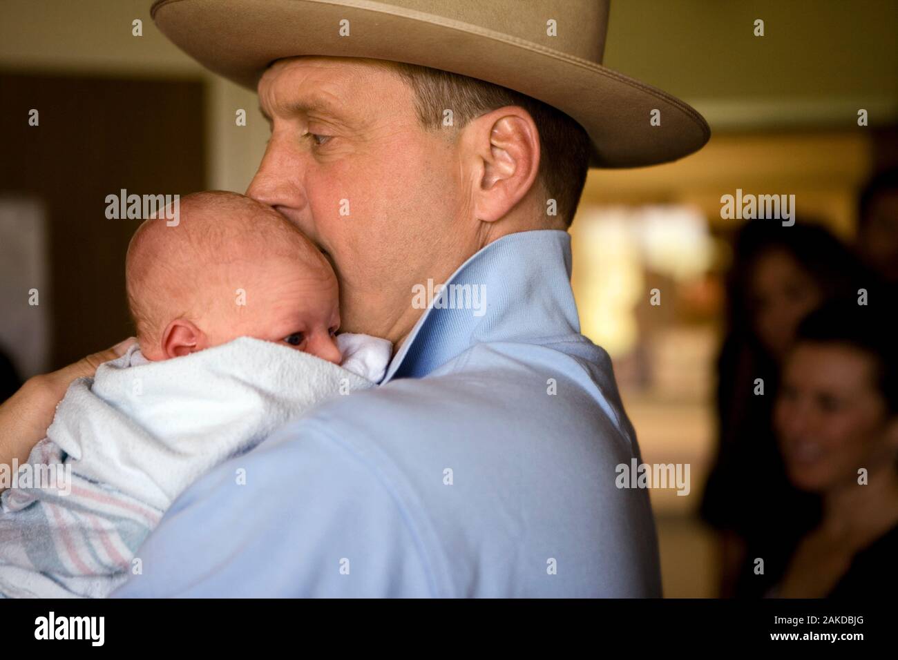 Side view of a father holding his child Stock Photo - Alamy