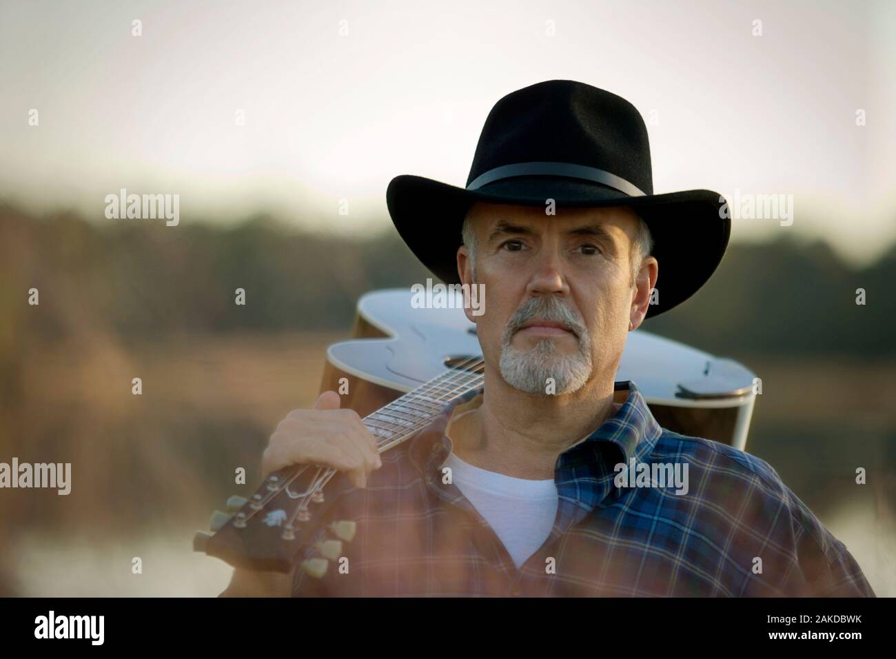 Male holding guitar over shoulder hi-res stock photography and images ...