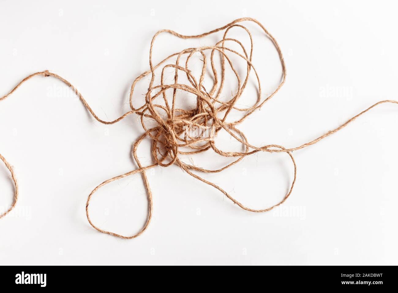 Tangled thread isolated on white illustrating concepts of complex problem, obstacle, stress ...