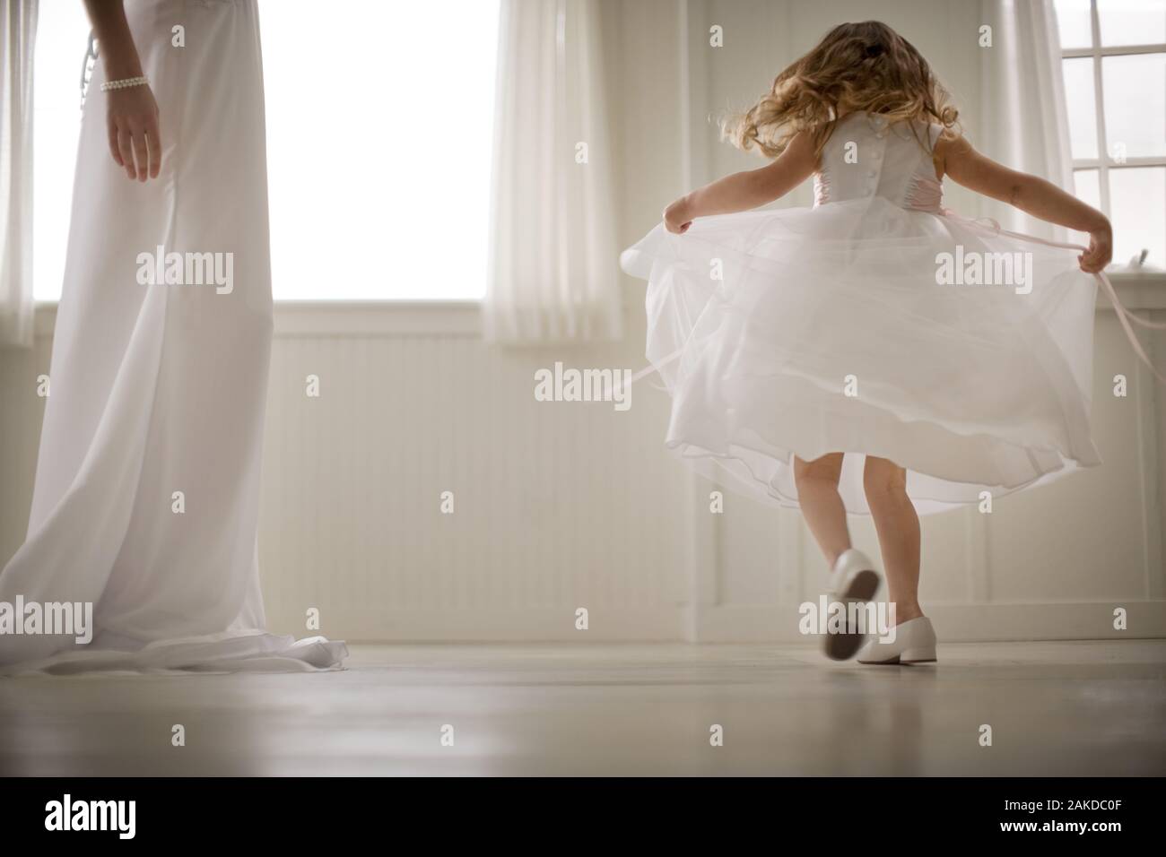 Young girl twirling around in a white dress Stock Photo - Alamy