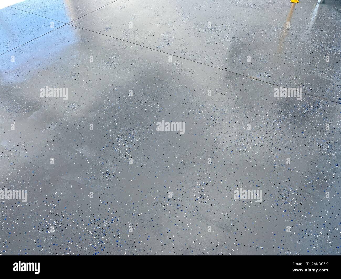 A freshly painted with a gray epoxy finish sprinkled with blue, black ...