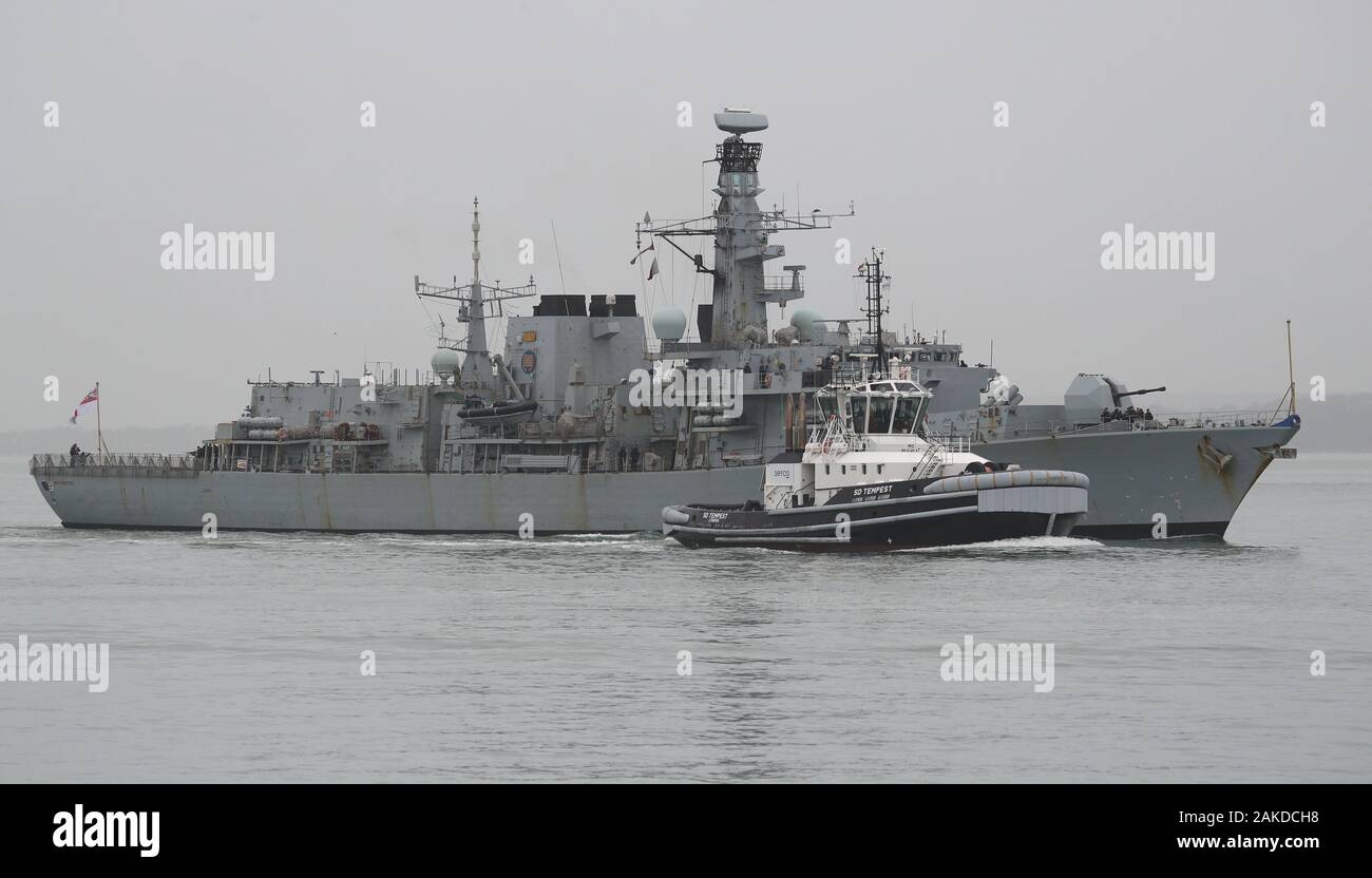 The tug boat SD Tempest helps guide the Royal Navy Type 23 frigate HMS ...