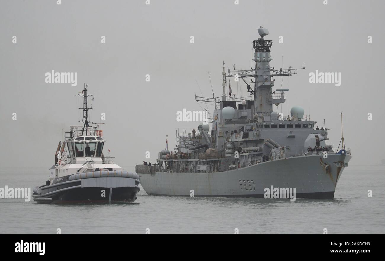 The tug boat SD Tempest helps guide the Royal Navy Type 23 frigate HMS ...
