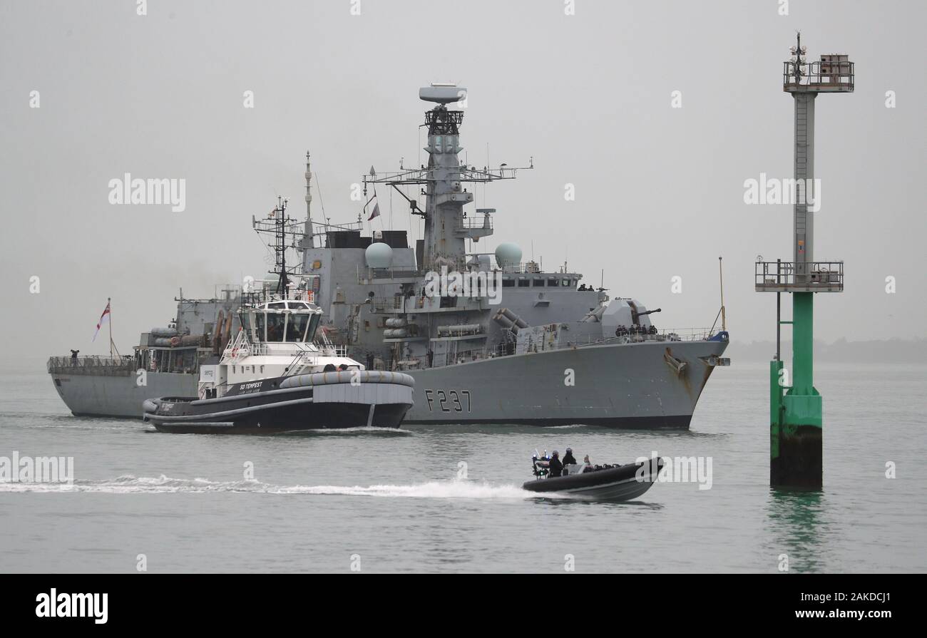 The tug boat SD Tempest helps guide the Royal Navy Type 23 frigate HMS ...