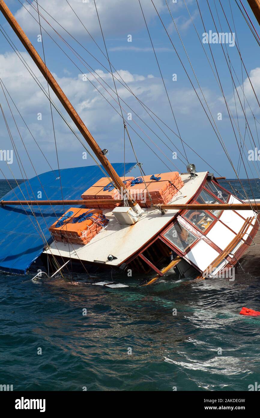 A schooner listing to its side and slowly sinking Stock Photo - Alamy