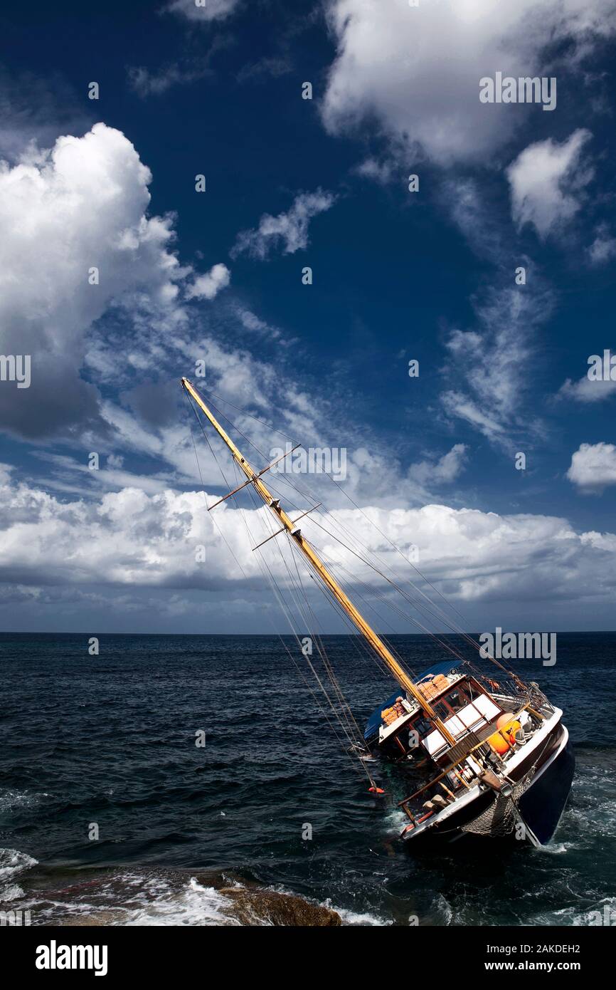 Schooner shipwrecked and beached on coastline rocks Stock Photo - Alamy