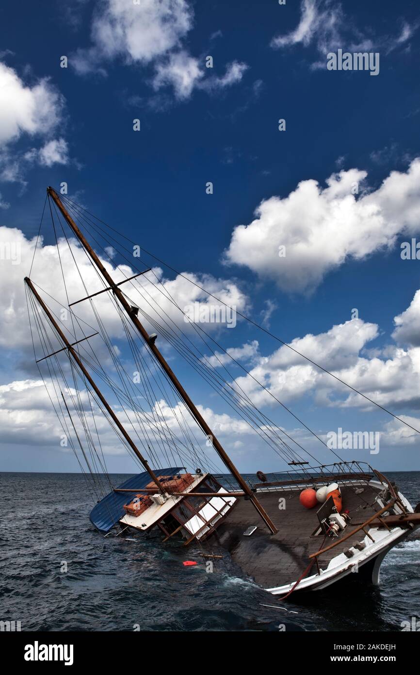 A schooner listing to its side and slowly sinking Stock Photo - Alamy