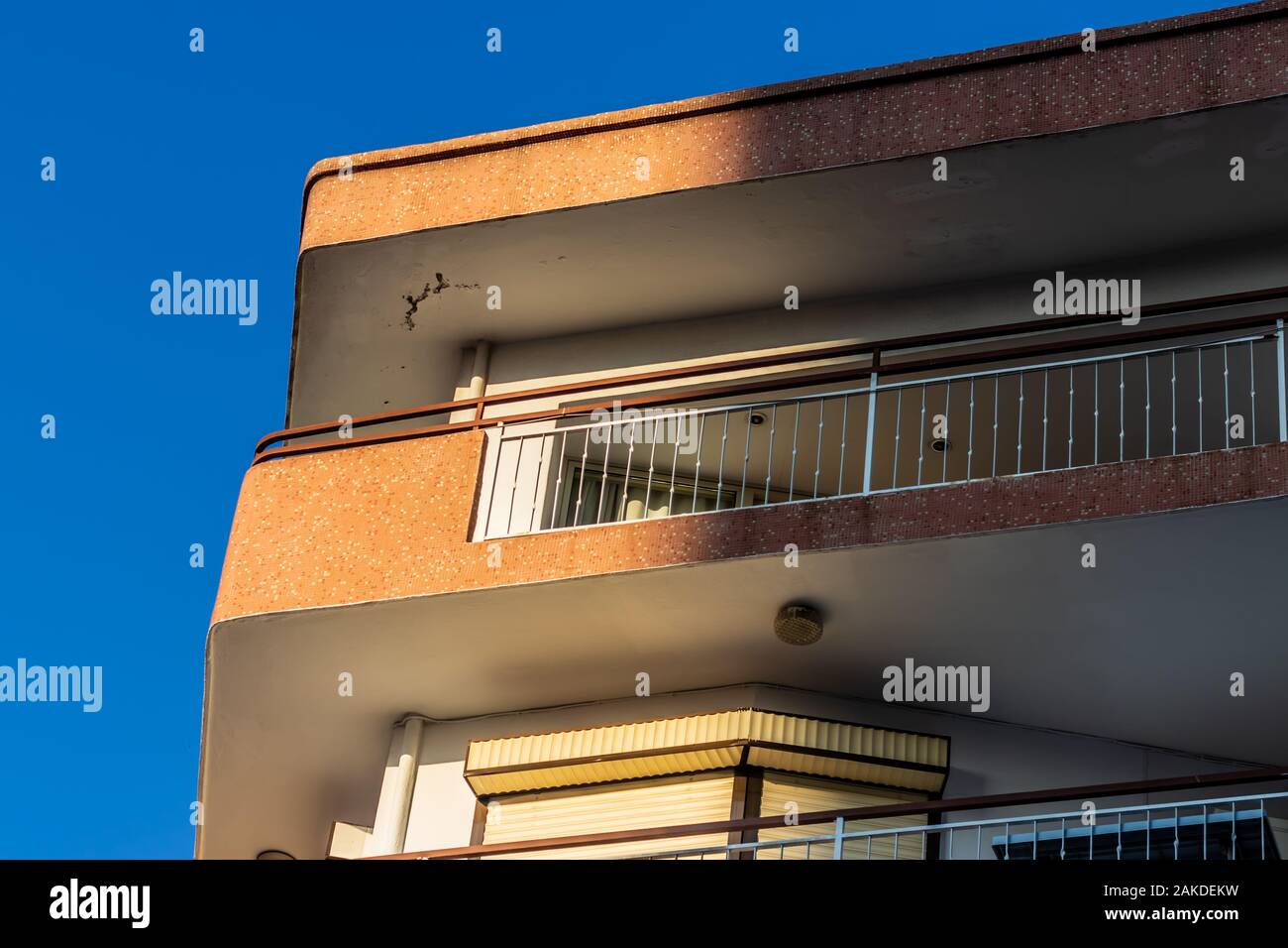 a corner perspective shoot to an old building with orange walls. photo ...