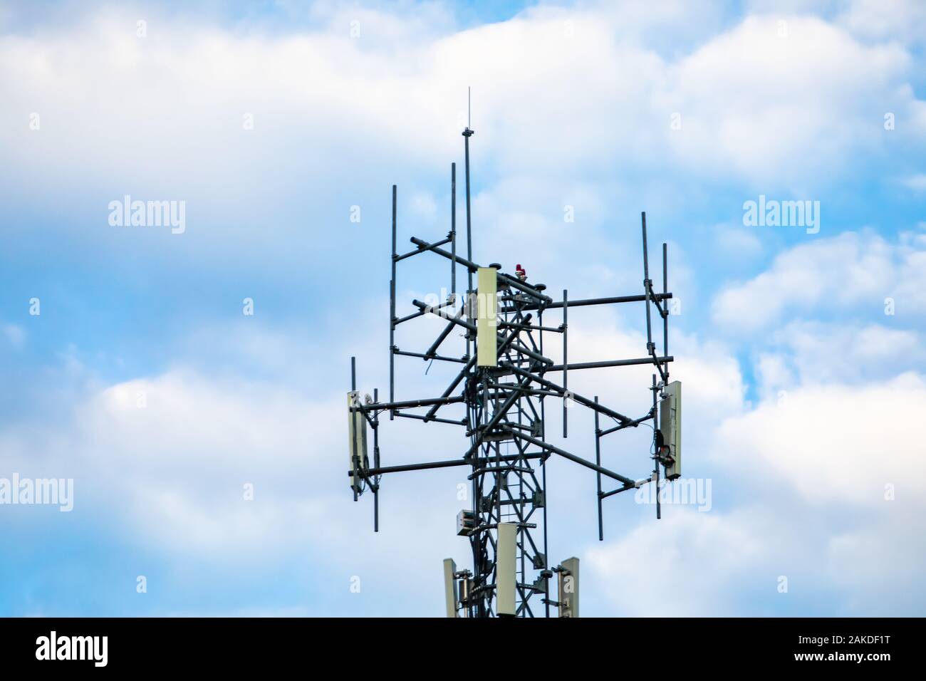 A low angle close up shot of a cell site tower, lattice design, housing ...