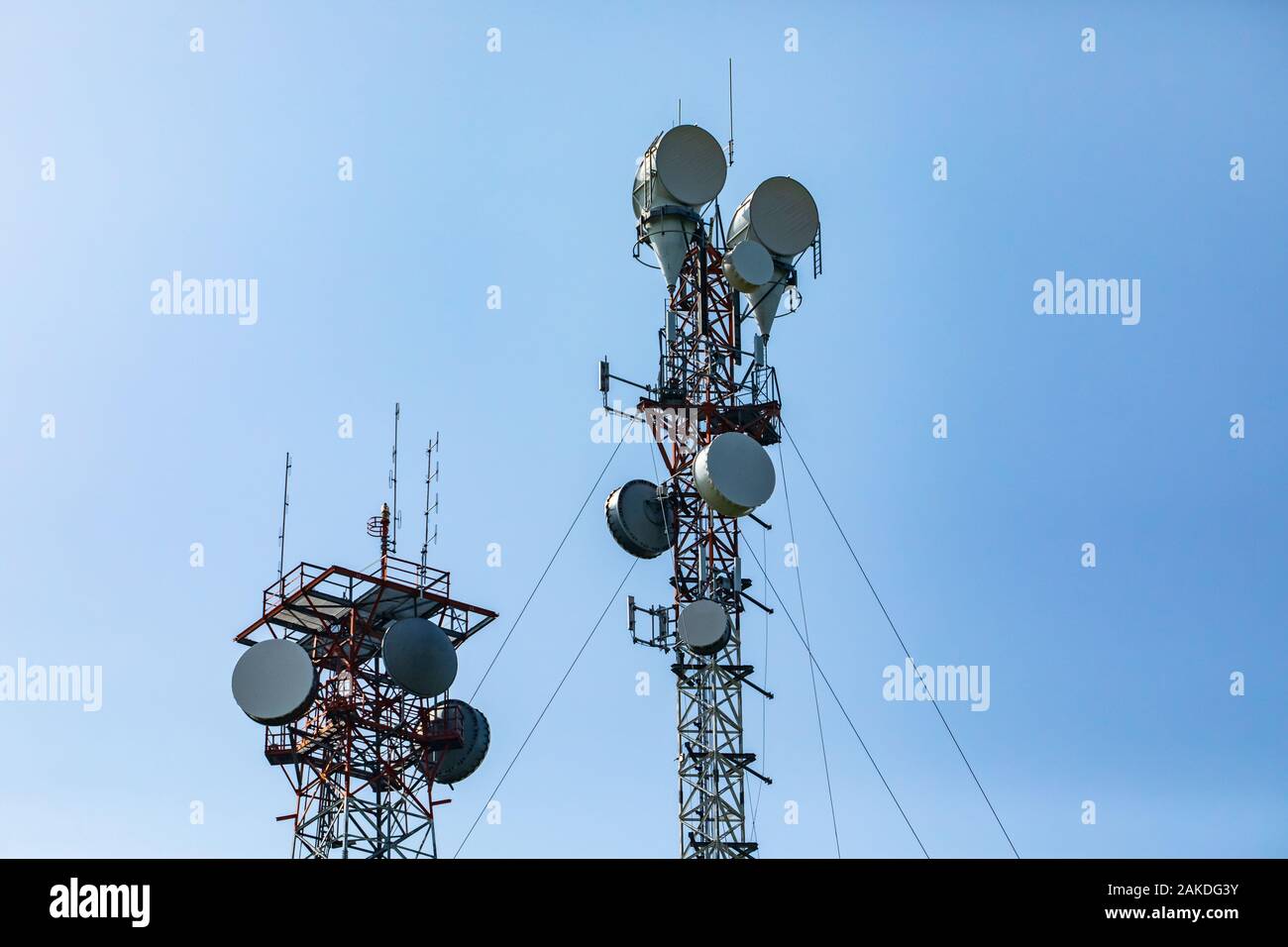 Telecommunication and mobile network infrastructure with two cell site towers side by side ...