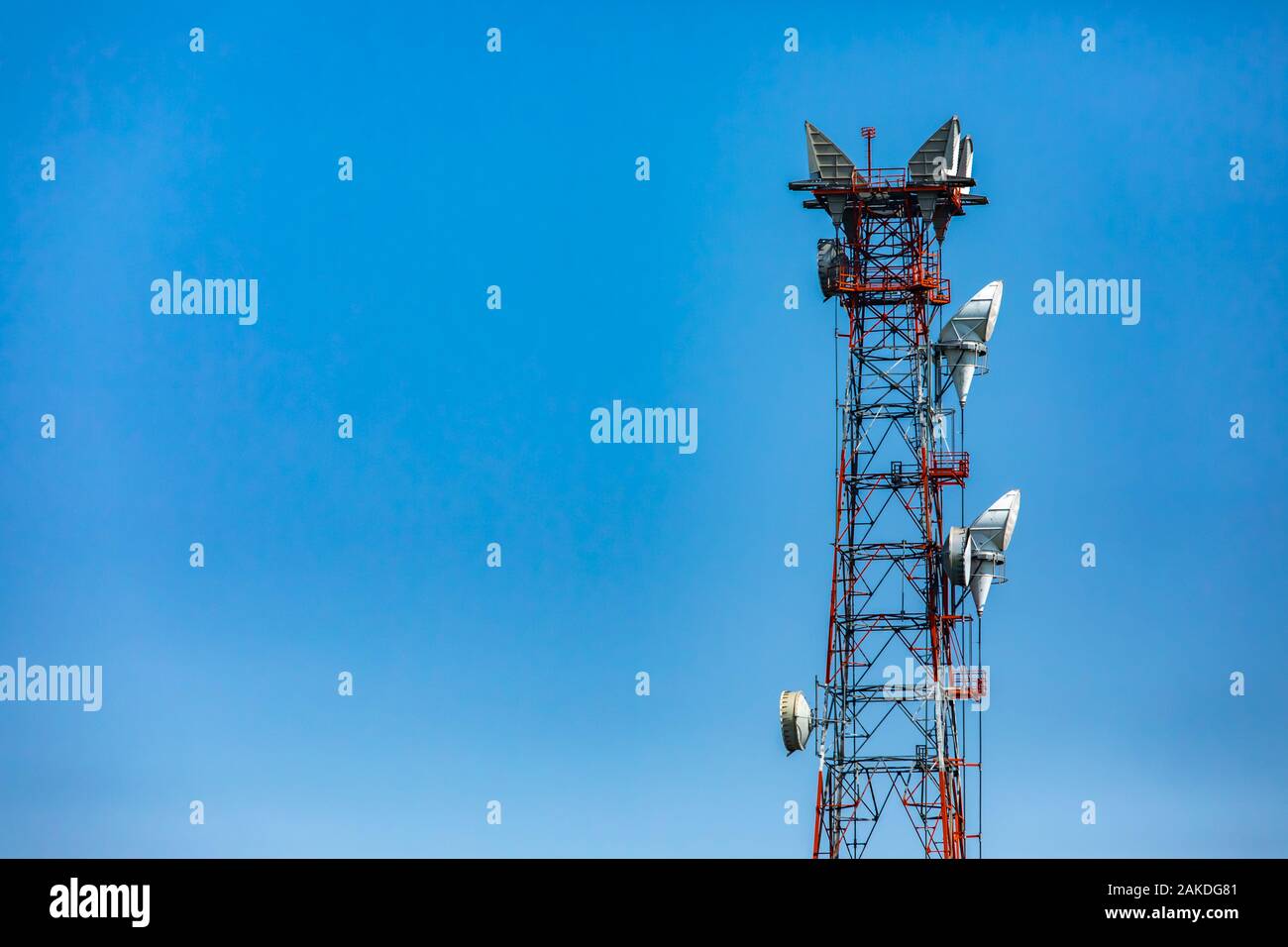 A lonely cellular network tower is seen against a clear blue sky. GPS ...