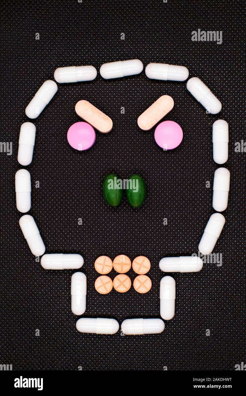 different colors and shapes of medical tablets lined in the form of a ...