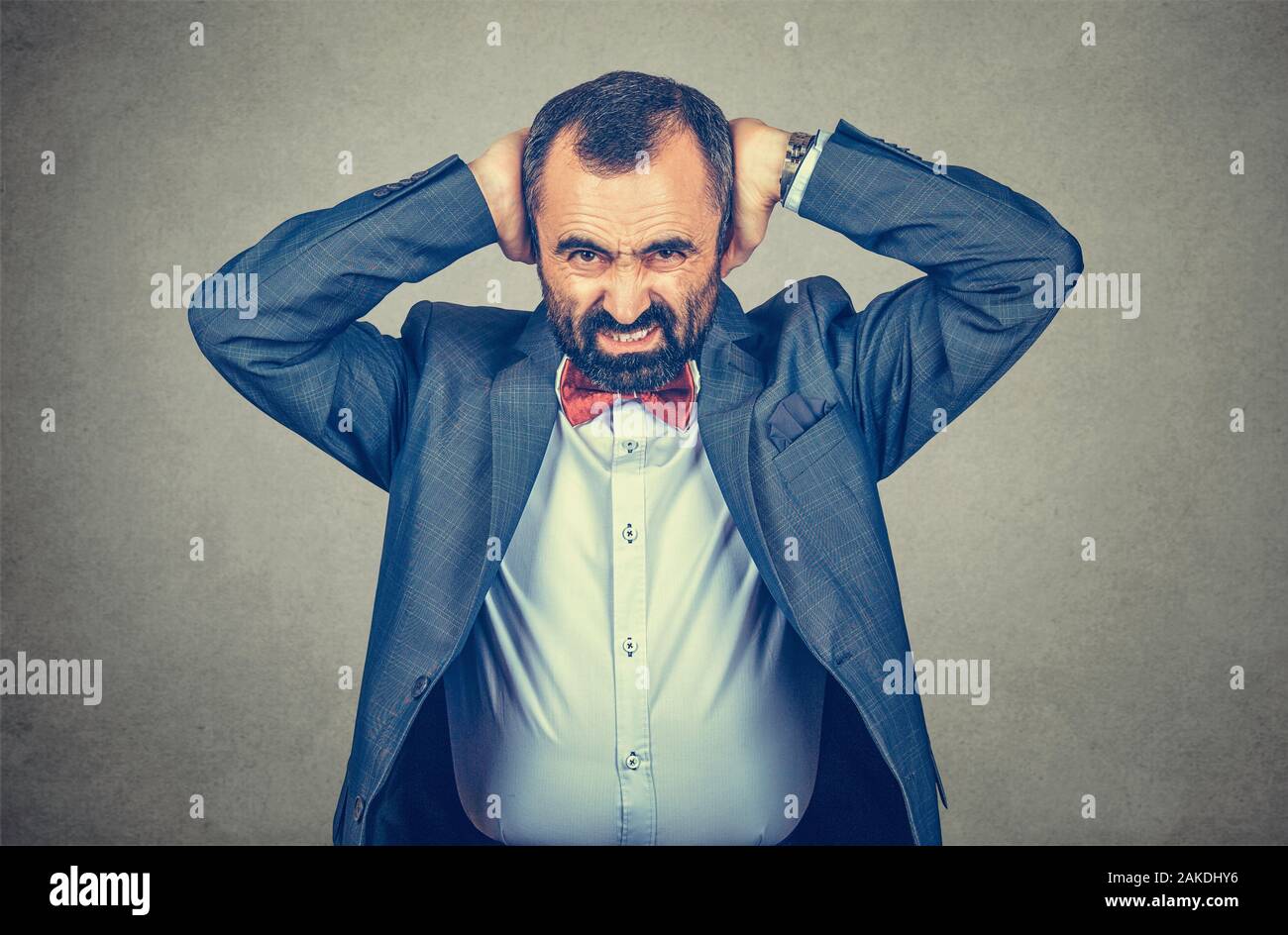 Closeup portrait adult angry bearded man in elegant jacket with red bow ...