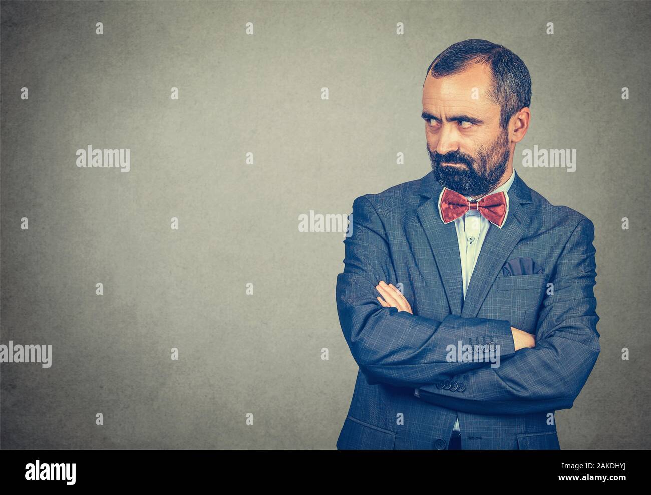 Jealousy, envious. Serious adult gloomy bearded man in elegant suit ...