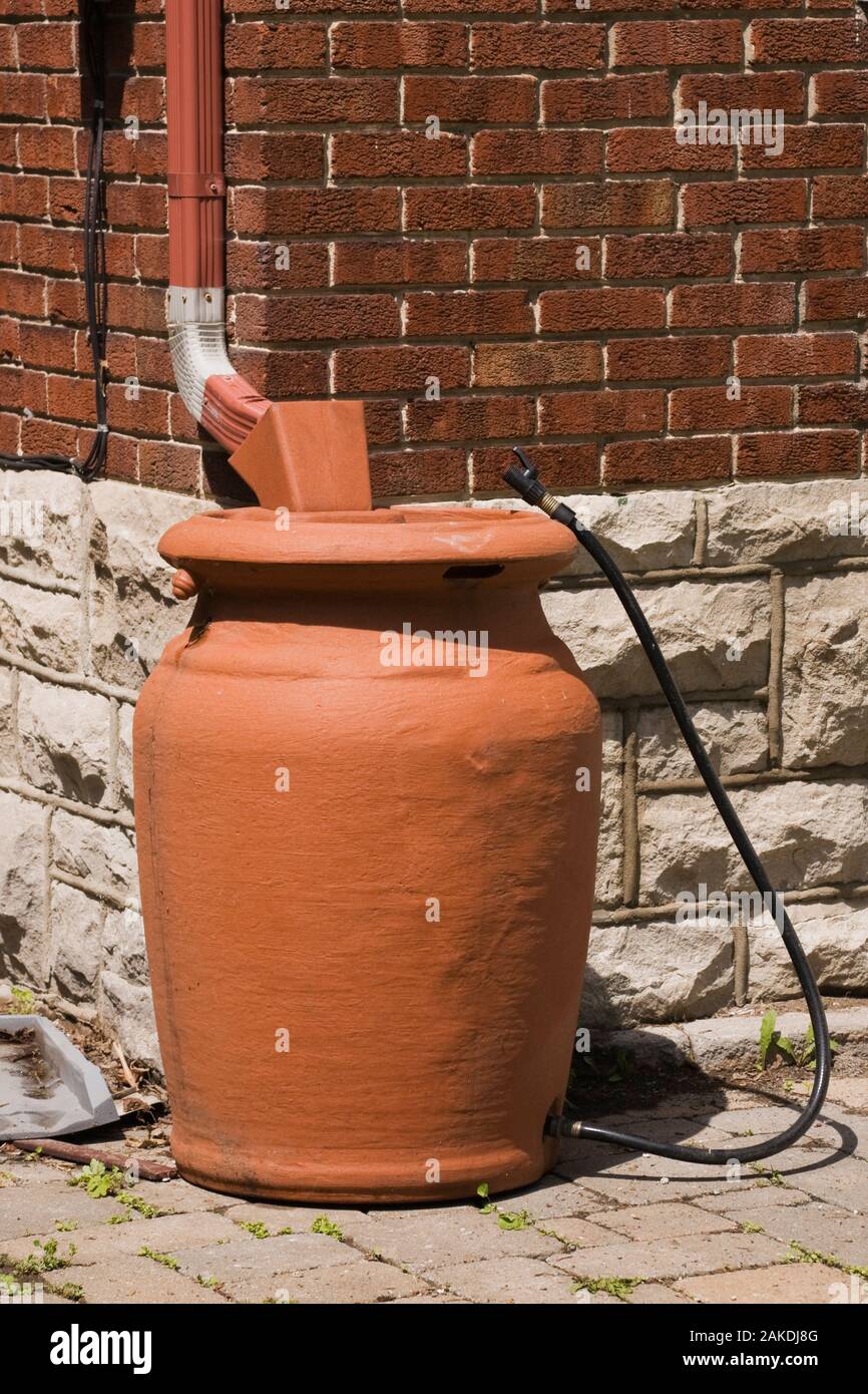 Rainwater downspout on the side of a red brick house wall connected to ...