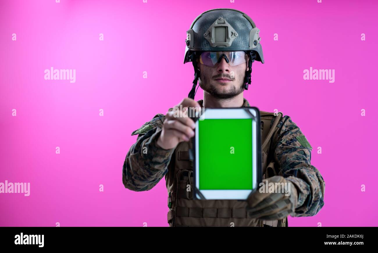 army soldier showing a tablet computer with a blank green screen ...