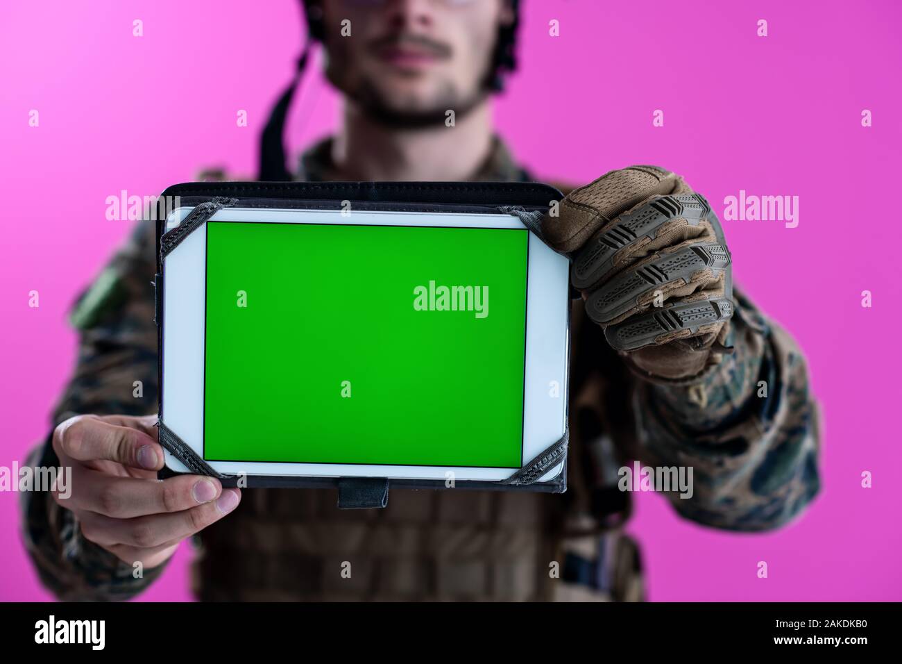 army soldier showing a tablet computer with a blank green screen ...