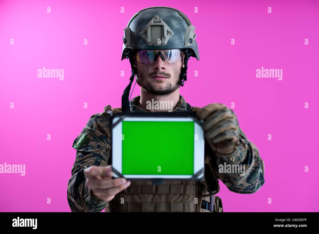 army soldier showing a tablet computer with a blank green screen ...